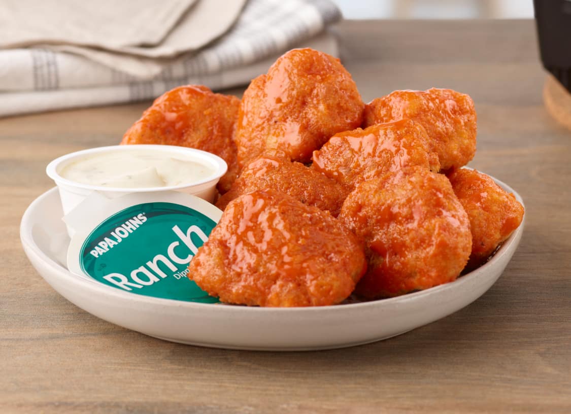 Buffalo Chicken Poppers, Oven-baked poppers drizzled with Buffalo sauce.